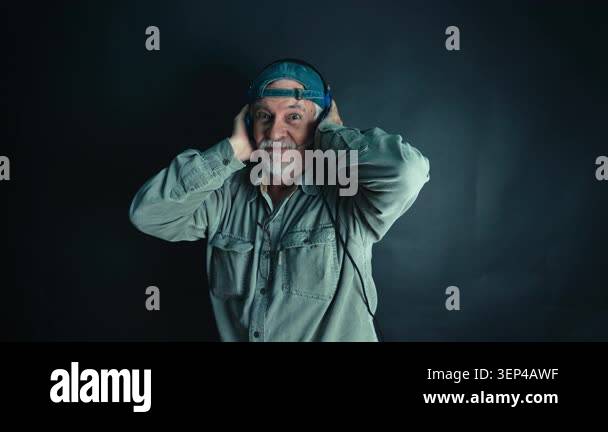 Senior Old Man Listening to Music with Headphones Stock Video Footage ...