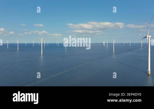Aerial view of a wind farm with multiple wind turbines located on the ...