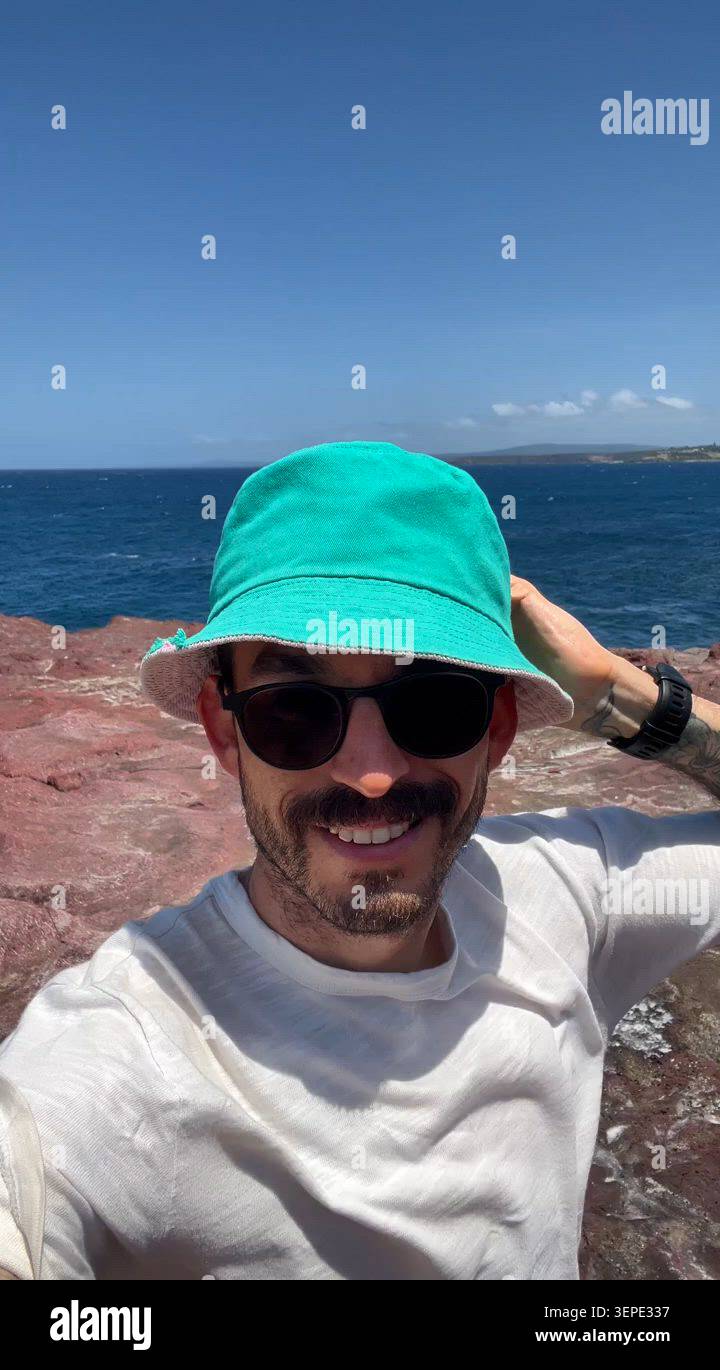 Man wearing a hat by the Ocean in Merimbula Stock Video Footage - Alamy
