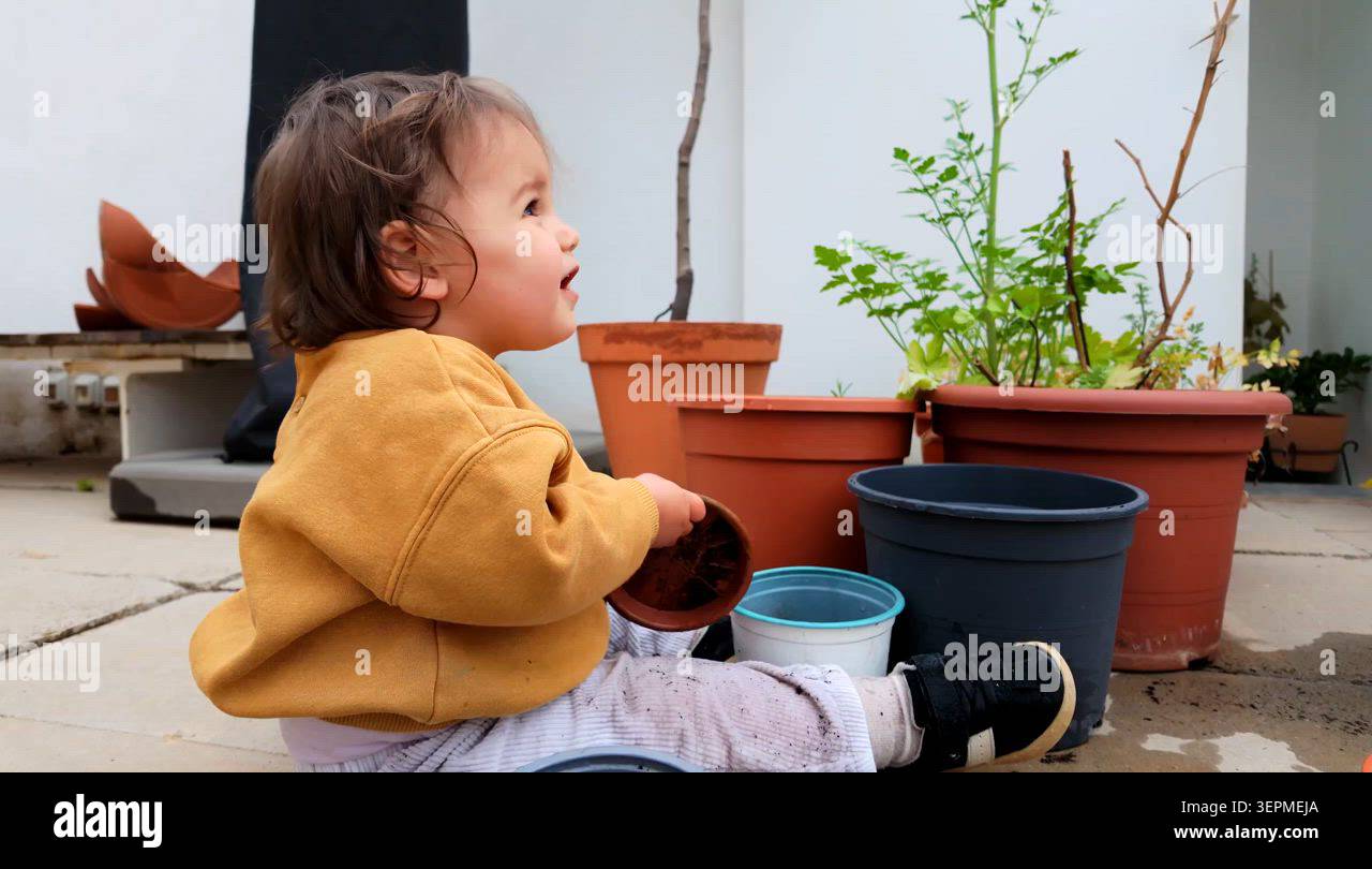Toddler Watering Soil During Terrace Gardening Stock Video Footage - Alamy