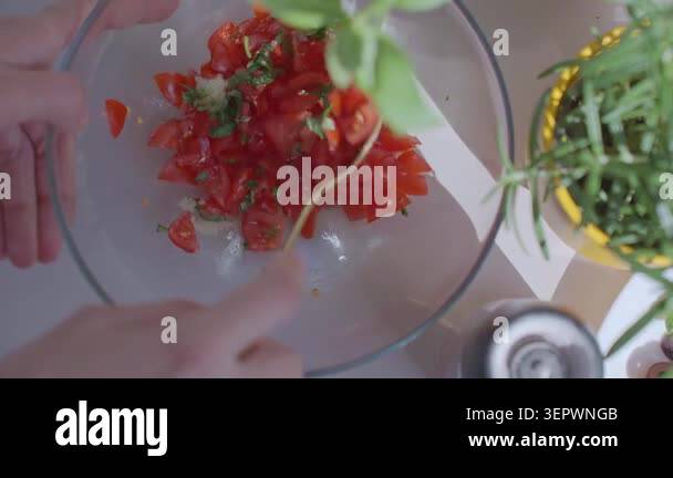 Chopped tomatoes with basil placed in glass bowl on sunny kitchen ...