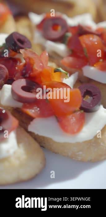 Close up of bruschetta with tomato, mozzarella and olives on toasted ...