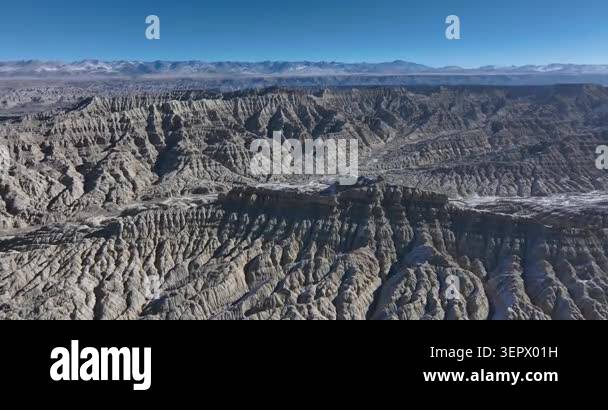 Aerial drone footage captures the vast, rugged landscape of a barren ...