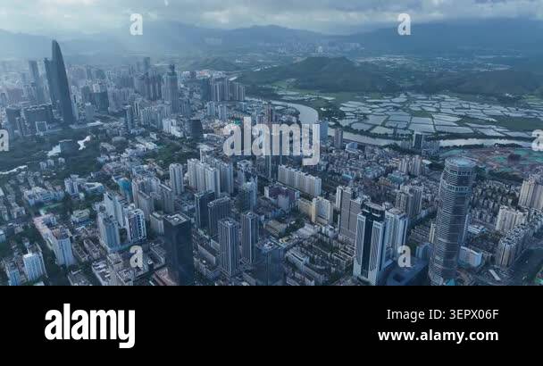 Aerial drone footage flying over a dense cityscape with tall ...