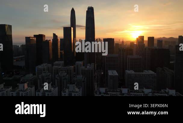 Aerial view of a modern city skyline at sunset with tall skyscrapers ...
