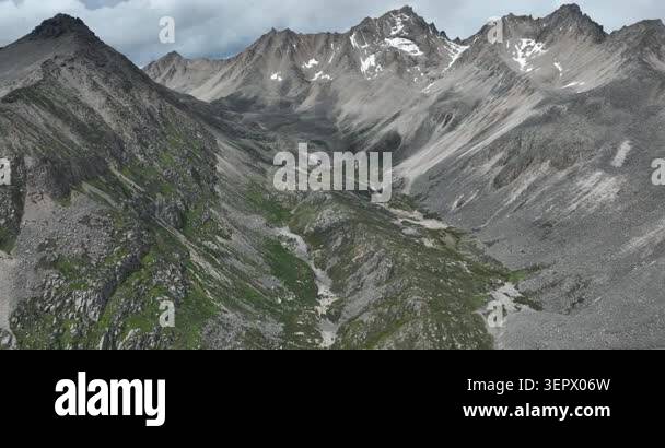 Aerial drone footage flying over a vast, rugged mountain range with ...