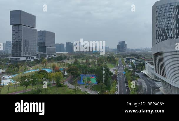 Aerial drone footage captures a modern cityscape with tall buildings ...