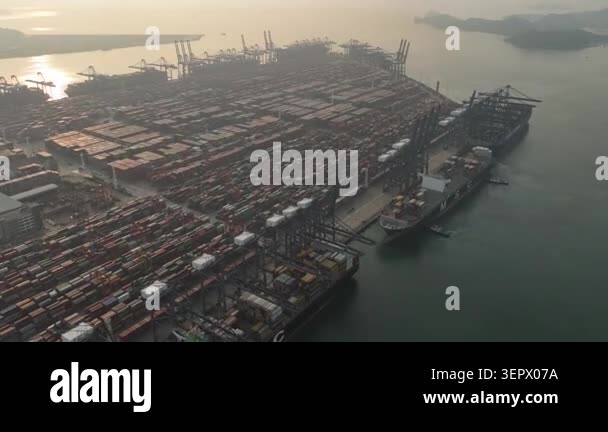 Aerial drone footage of a massive container port with ships and cranes ...