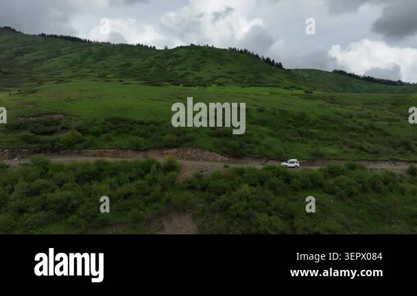 Aerial footage car road trip on the high altitude mountain trail, China ...
