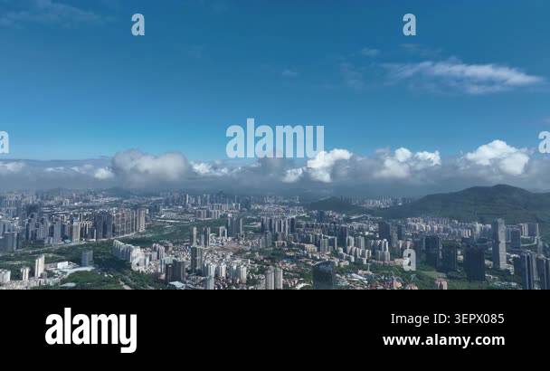 Aerial drone footage flying over a sprawling cityscape with numerous ...