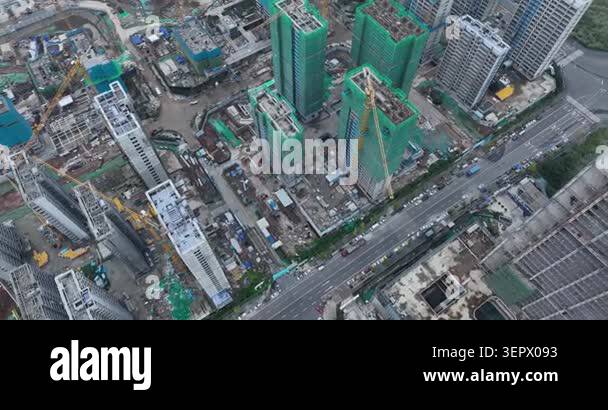 Aerial drone footage captures a sprawling urban construction site with ...