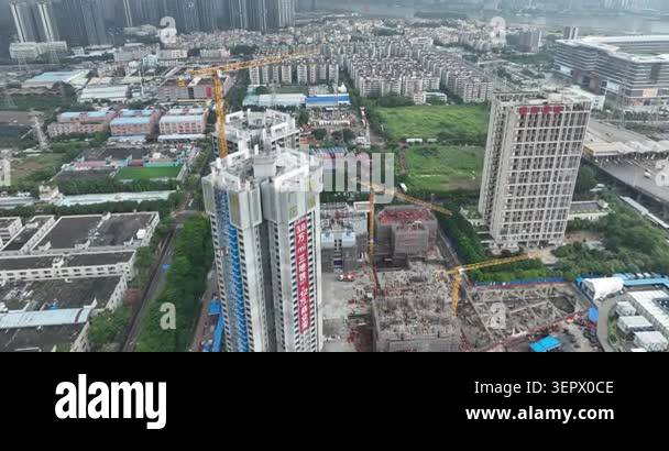 Aerial view of a city skyline with construction cranes and unfinished ...