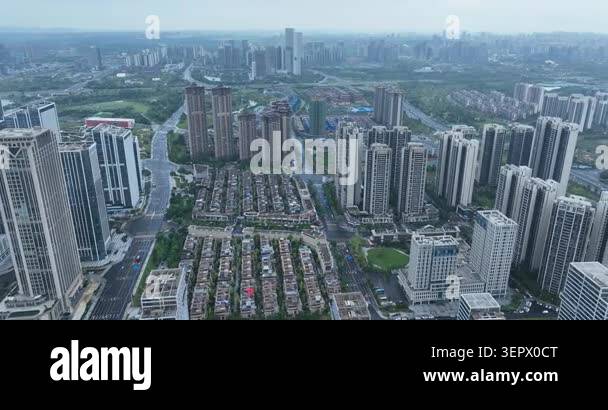 Aerial drone footage captures a sprawling cityscape with numerous high ...