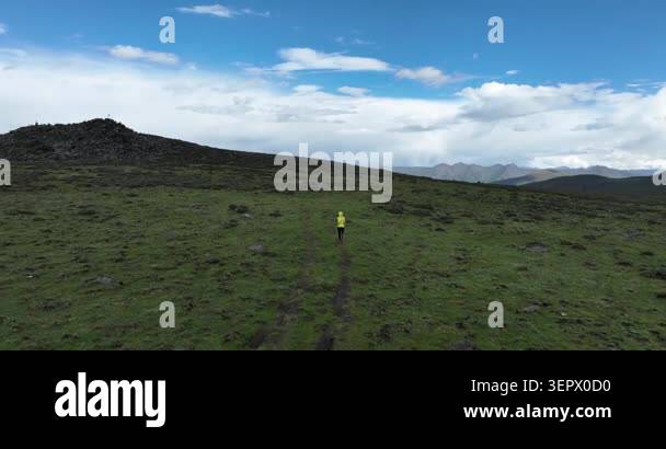 Aerial footage of woman trail runner cross country running on high ...