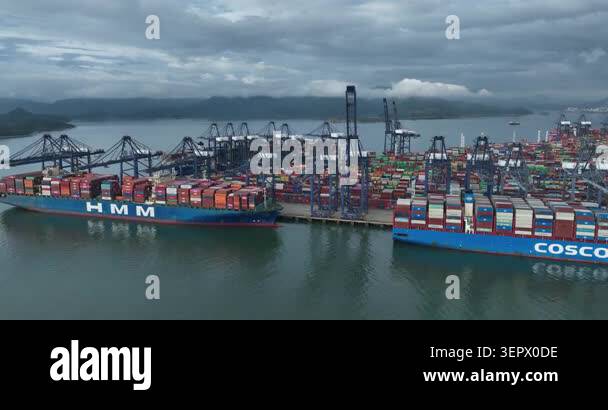 HMM logo, Aerial view of a busy container port with large cargo ships ...