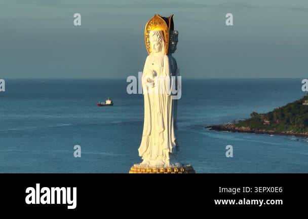 Aerial view of a large white statue of a deity with multiple faces ...