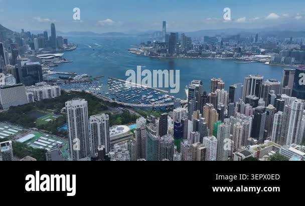 Aerial drone footage captures a sprawling cityscape with numerous ...