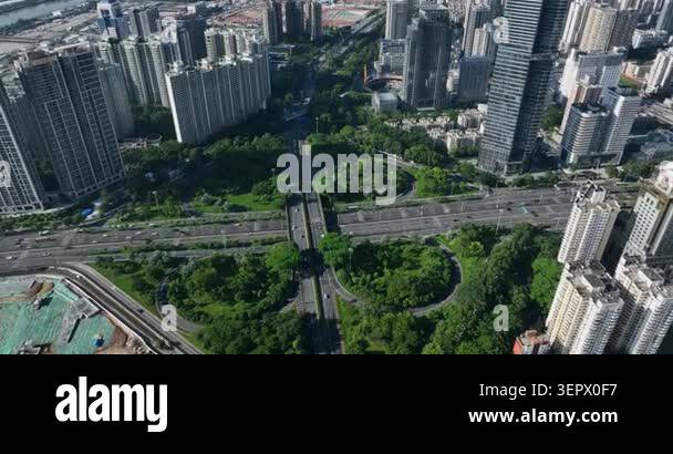 Aerial view of a complex highway interchange surrounded by lush green ...