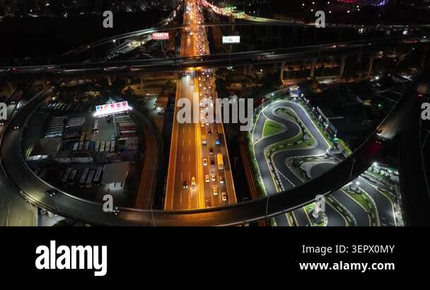 Guangzhou Circle, Aerial night view of a busy highway interchange with ...