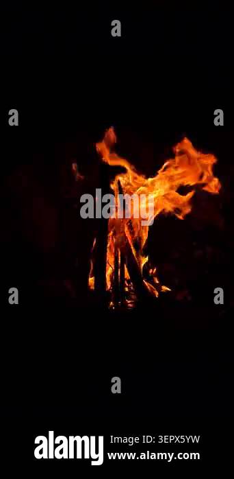 bright large bonfire lit at night while camping, for backgrounds ...