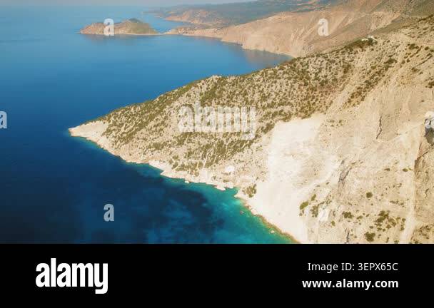 Aerial view of rugged coastline and calm blue sea of Kefalonia island ...
