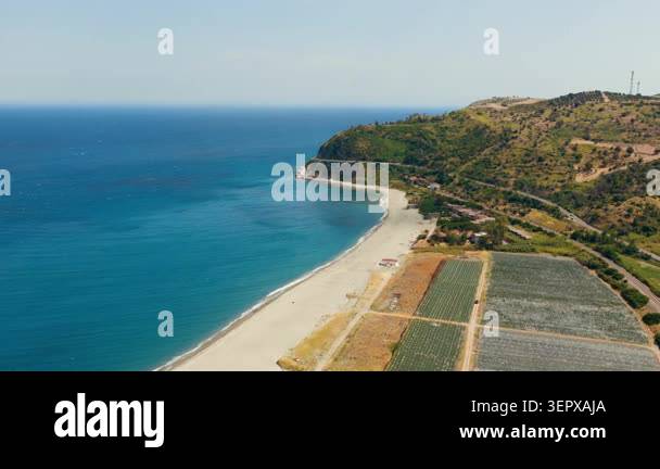 Aerial coastline view with beach and hillside village Stock Video ...