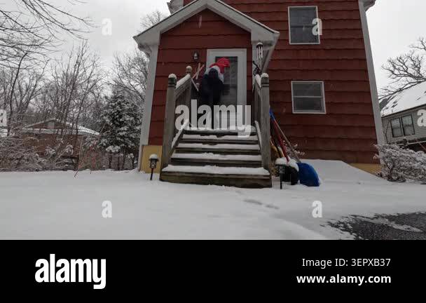 Time-lapse woman shoveling and salting stairs after the snow storm in ...