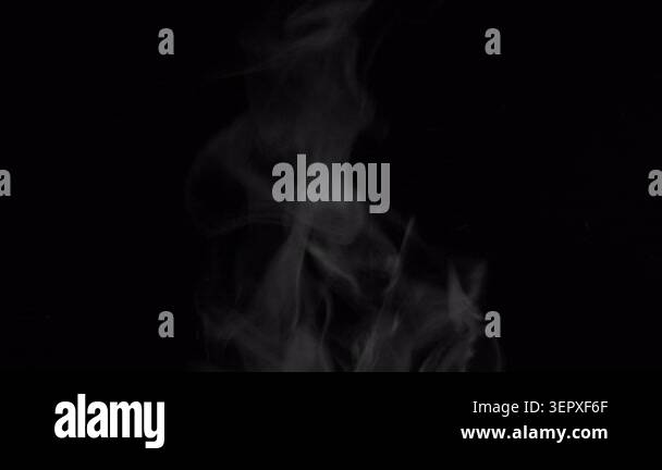 Natural steam movement captured over boiling water on a black ...