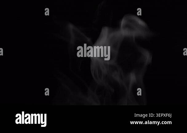 Natural steam movement captured over boiling water on a black ...