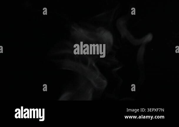 Natural steam movement captured over boiling water on a black ...
