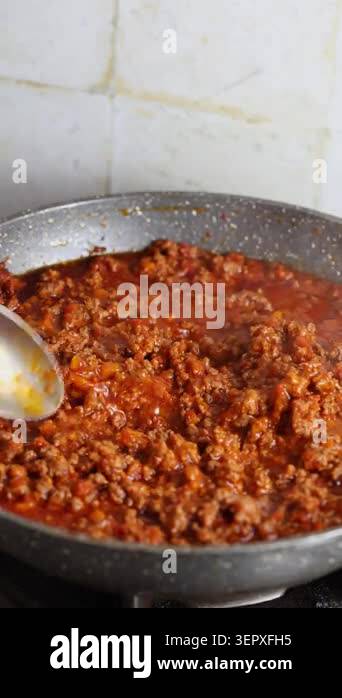 Close-up vertical shot of traditional Italian meat rag simmering in a ...