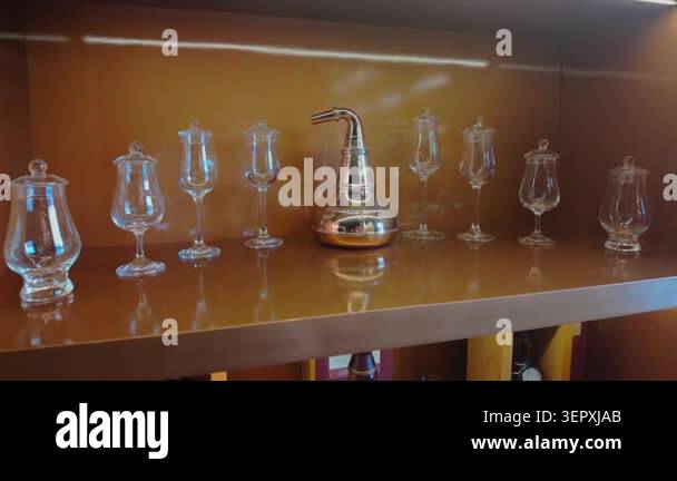 Transparent tasting glasses and pot still decanter arranged on a ...