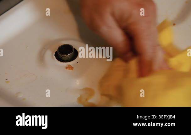 Man hand wiping and cleaning gas stove surface from food grease with ...