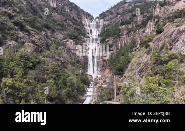 Aerial drone view of cascading waterfall Tiantai Mountain flowing over ...