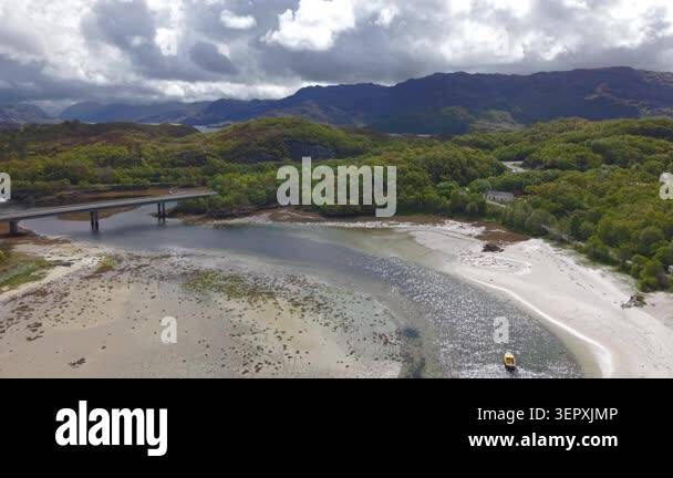High-angle static drone shot capturing the Morar Bridge, tidal river ...