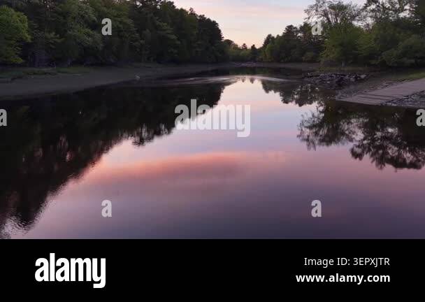 Moving slowly up the stream past the boat ramp near low tide on a calm ...