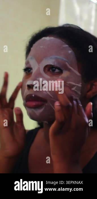 Young African American Woman caring for complexion during daily ...