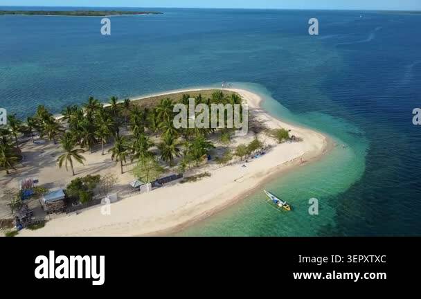 Aerial view of a small, idyllic island with white sand beaches, palm ...