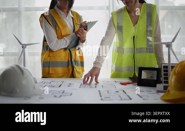 Two architects discussing plans wearing safety vests Stock Video ...