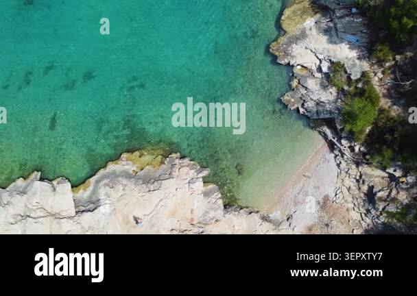 Incredible aerial top down view of maslinica beach, a secluded rocky ...