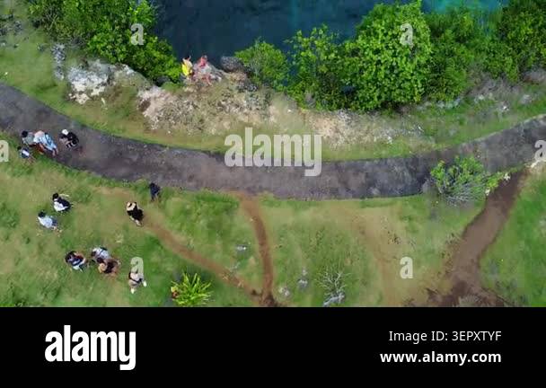 Aerial top down view of tourists exploring the scenic cliffs and ...
