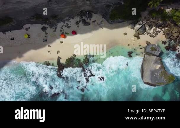 Incredible aerial top down view of tourists relaxing on the white sands ...