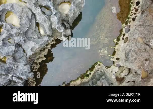 Natural rock formations creating a beautiful infinity pool with still ...