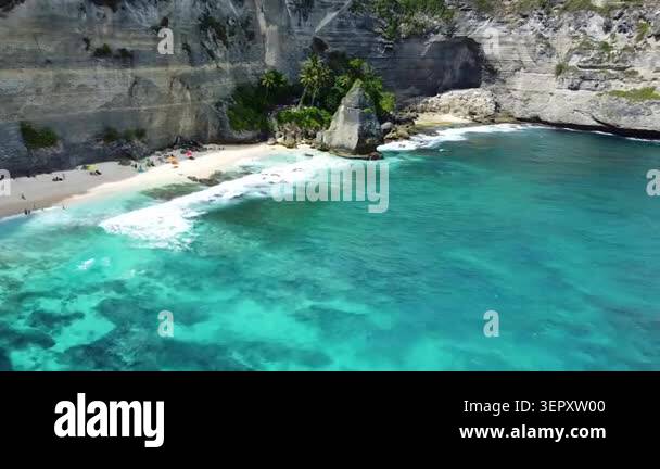Aerial view of people swimming and sunbathing on the white sand of ...