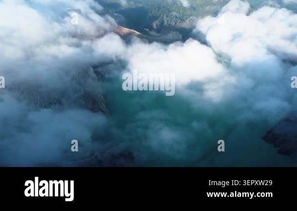 Amazing aerial view flying through fluffy clouds, revealing the ...