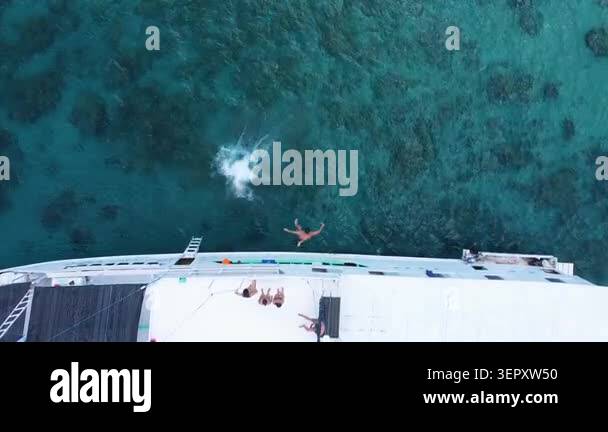Amazing aerial view of a group of friends having fun jumping from the ...