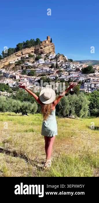 Vertical video showing woman with arms outstretched in front of a ...