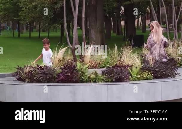 Carefree fun. Happy family park. Energetic smiling mother son playing ...