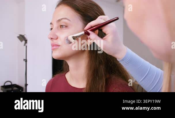 Beauty treatment. Cosmetic service. Professional makeup artist applying ...