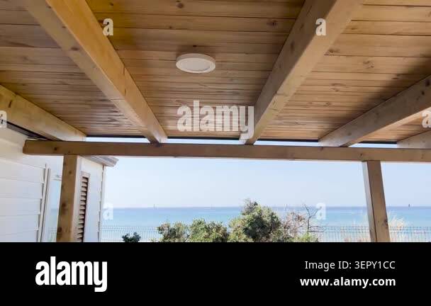 Calm mediterranean sea view from a wooden porch on a sunny summer day ...
